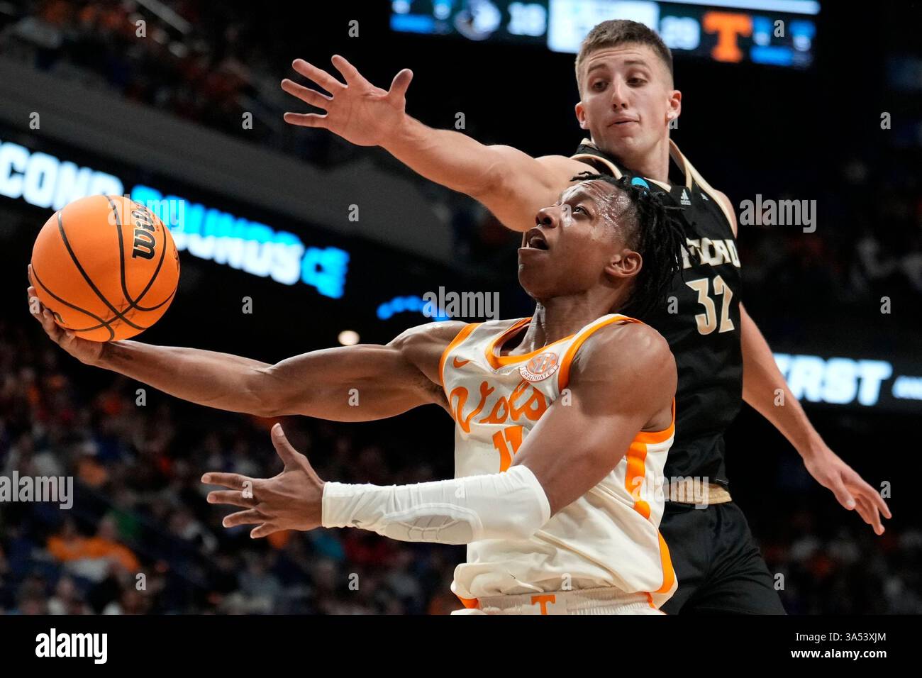 Tennessee guard Jordan Gainey (11) moves by Wofford forward Jeremy ...