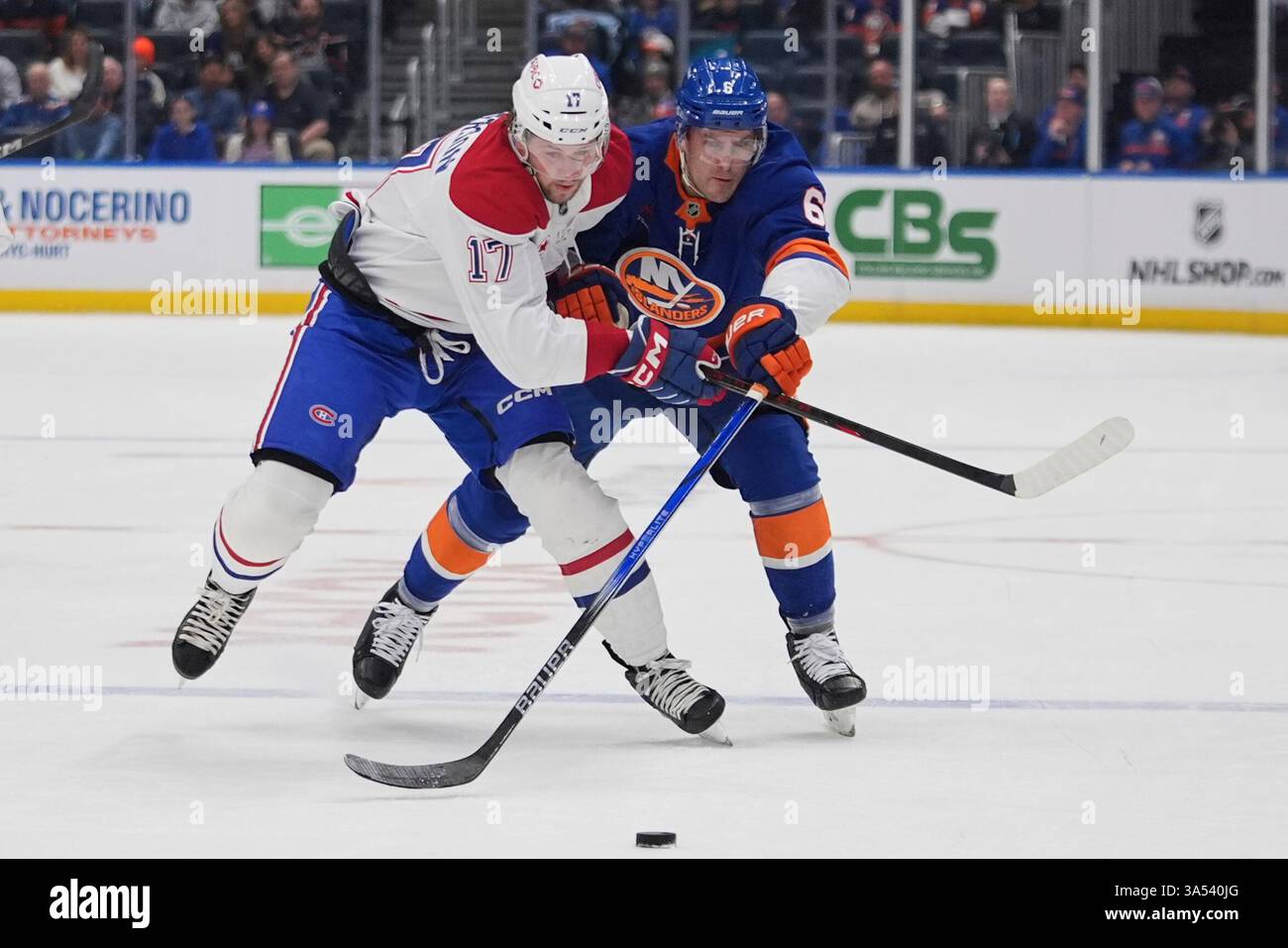 Montreal Canadiens' Josh Anderson (17) fights for control of the puck with New York Islanders ...