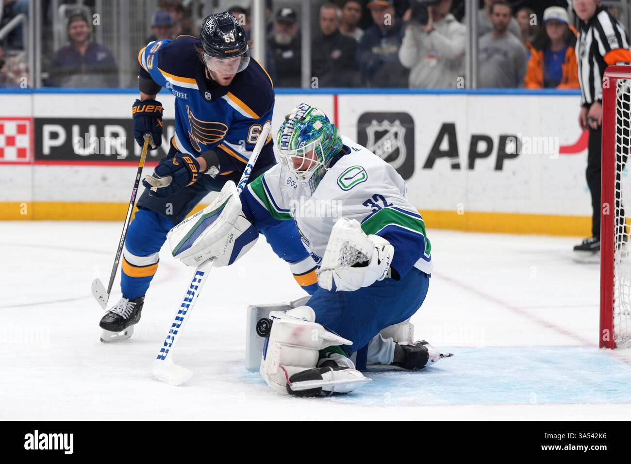 Vancouver Canucks goaltender Kevin Lankinen (32) stops a puck as St ...