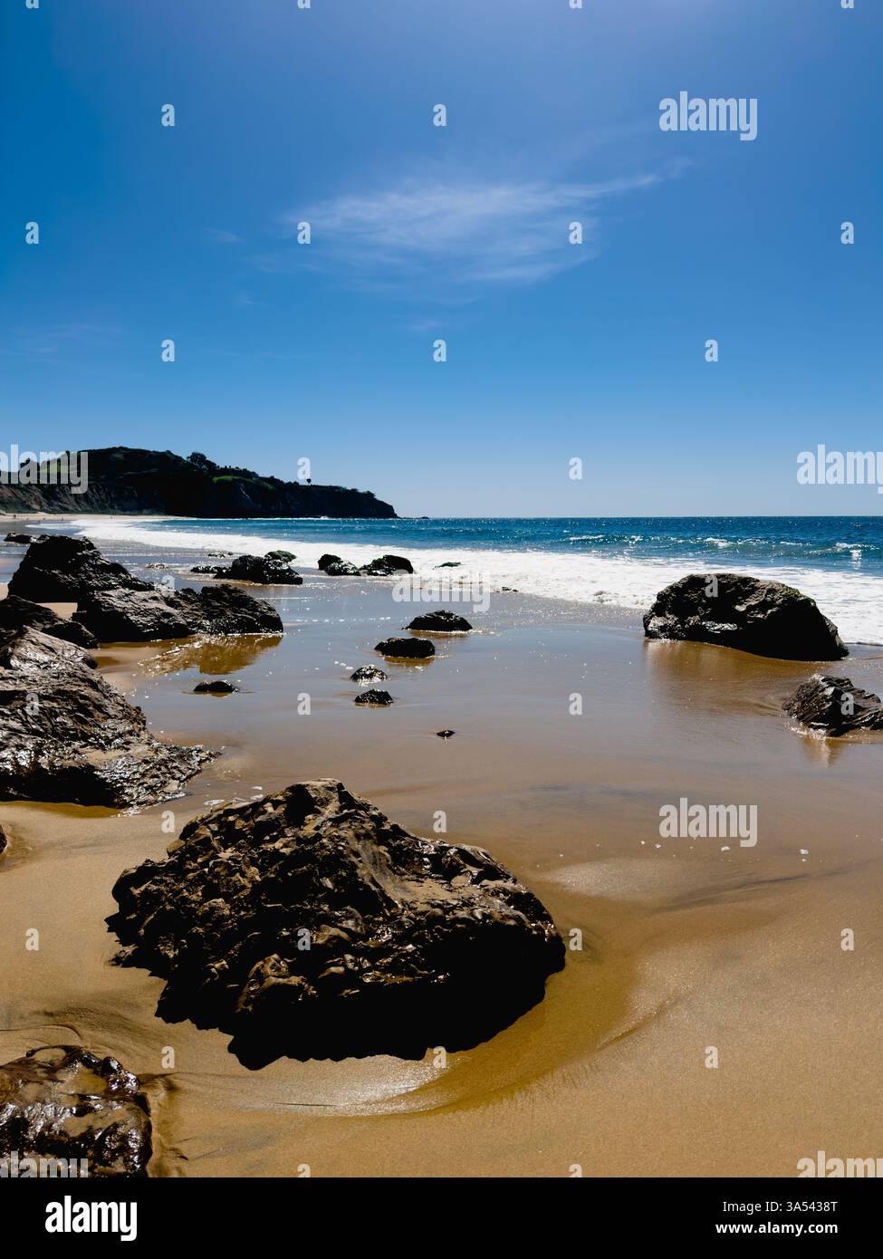 Sunny beach scattered rocks hi-res stock photography and images - Alamy