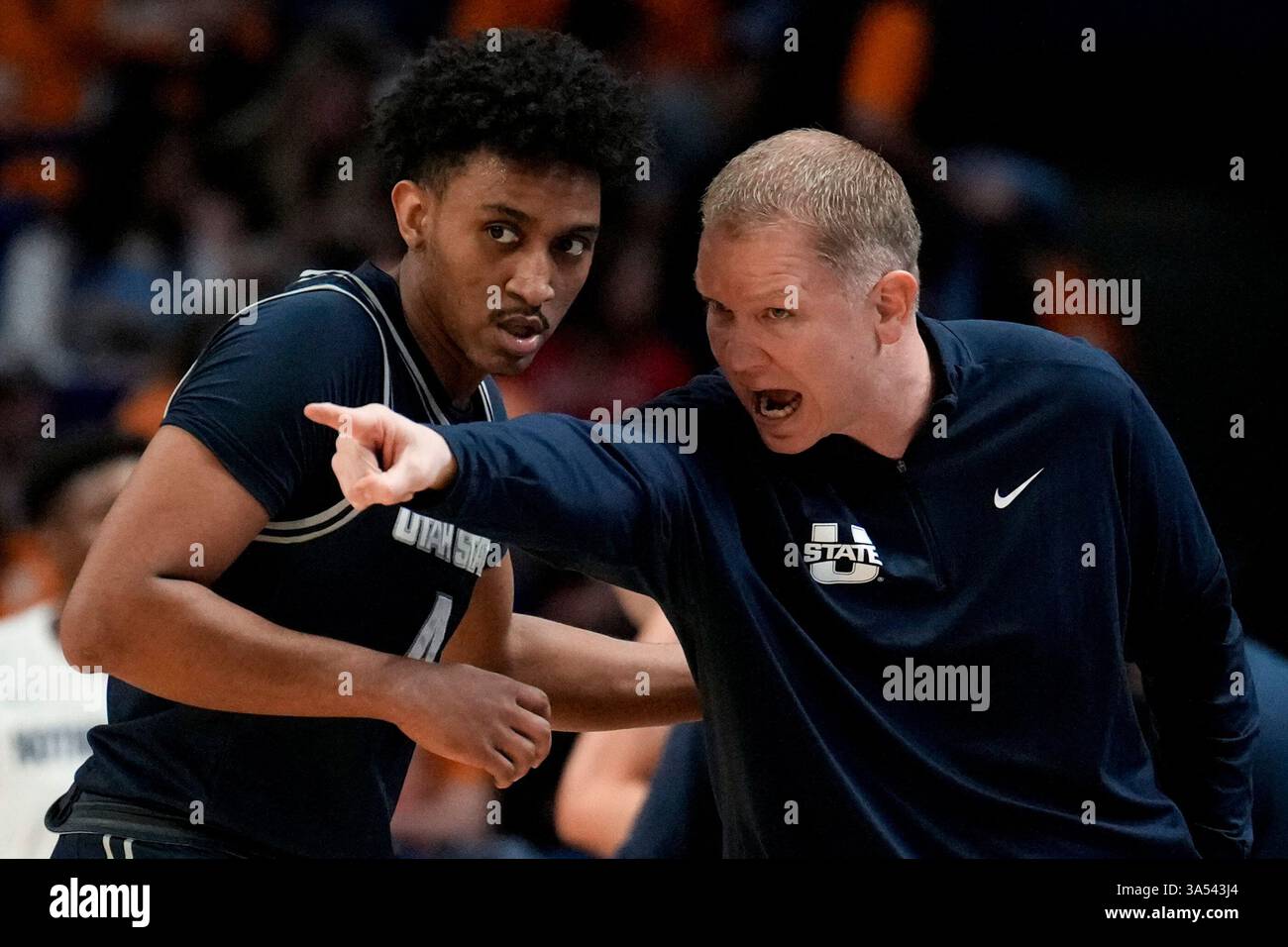 Utah State head coach Jerrod Calhoun speaks with Ian Martinez (4 ...