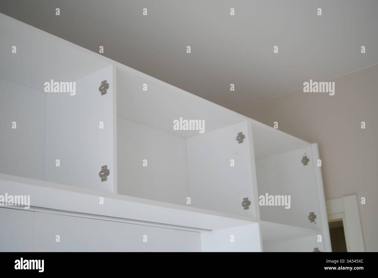 Modern white shelving units in a minimalistic interior design Stock ...