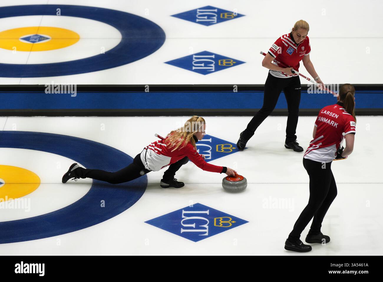 Denmark's skip Madeleine Dupont, left, releases the stone during the ...