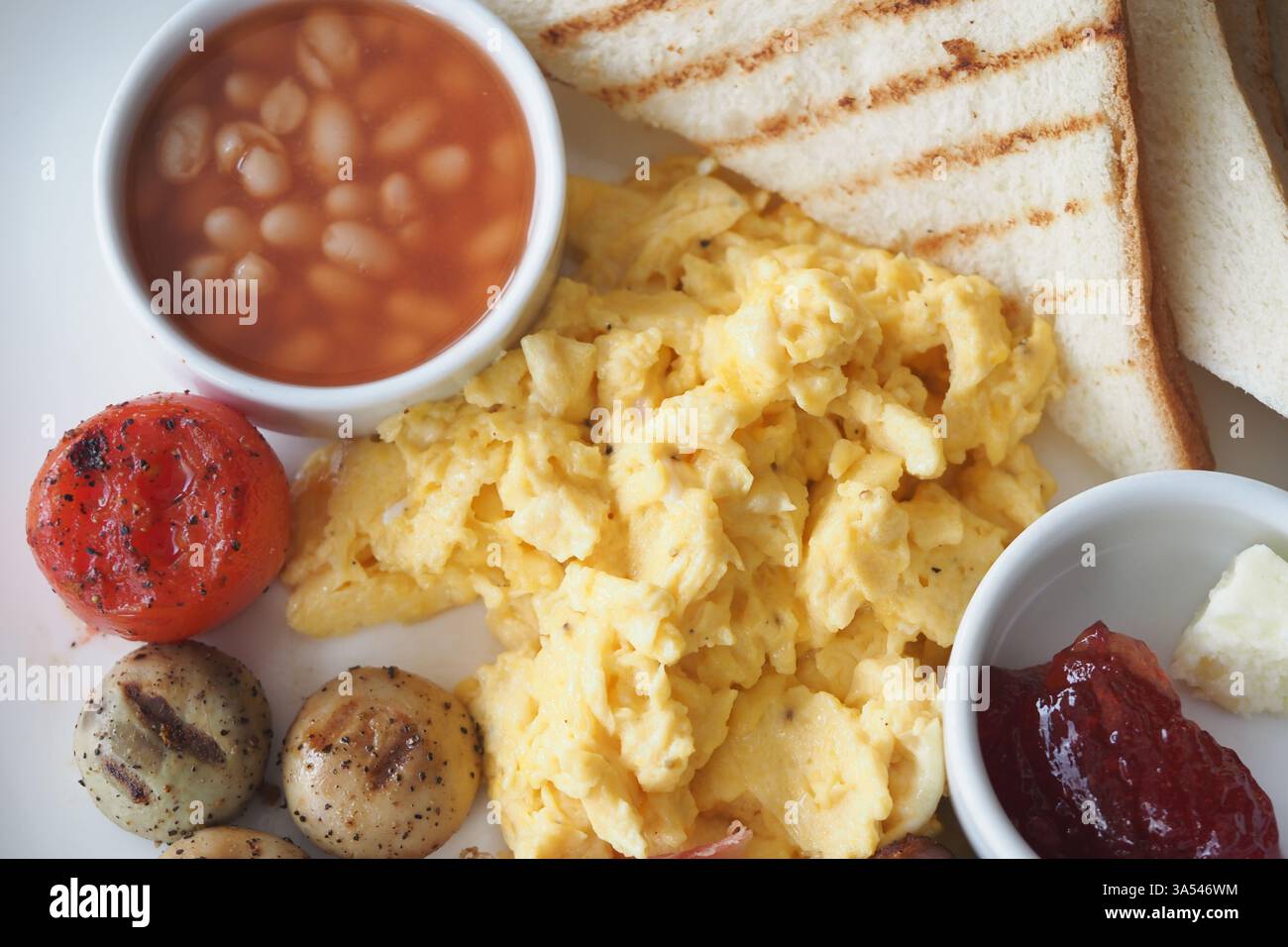 Classic breakfast platter featuring eggs, toast, and beans Stock Photo ...