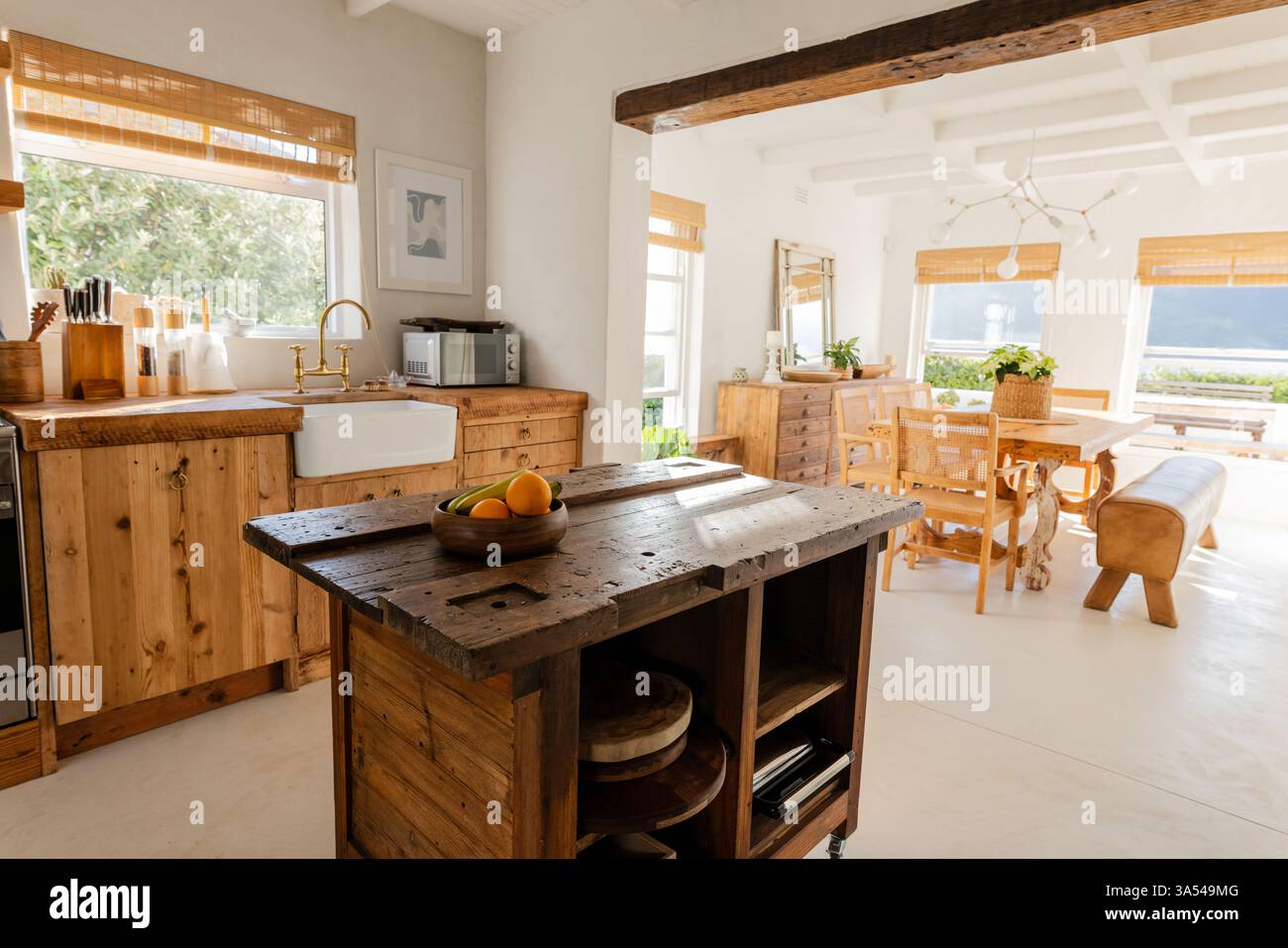 Sunlight streaming through windows, rustic kitchen with wooden ...