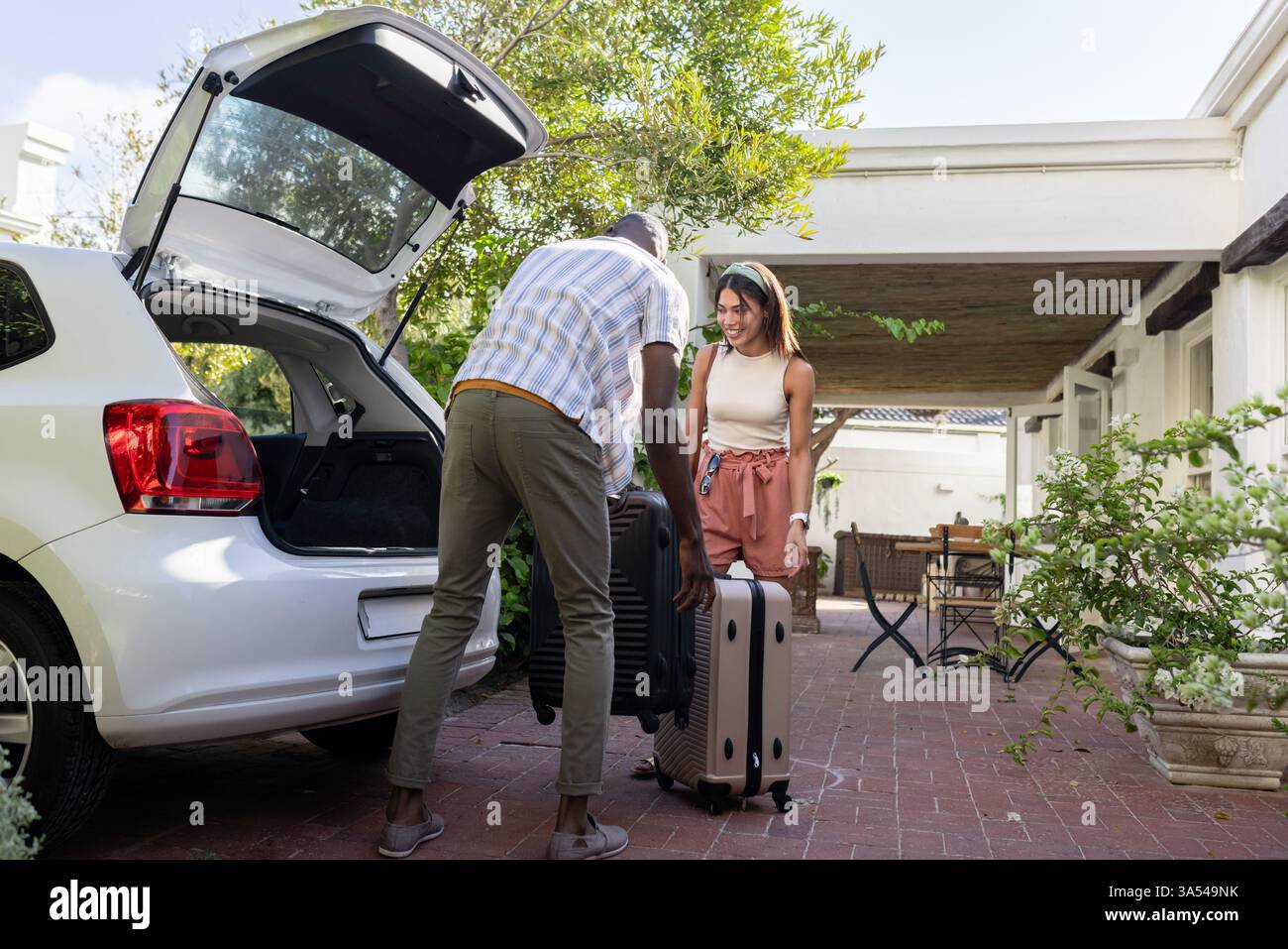 Packing car with suitcases, Diverse couple preparing for vacation ...