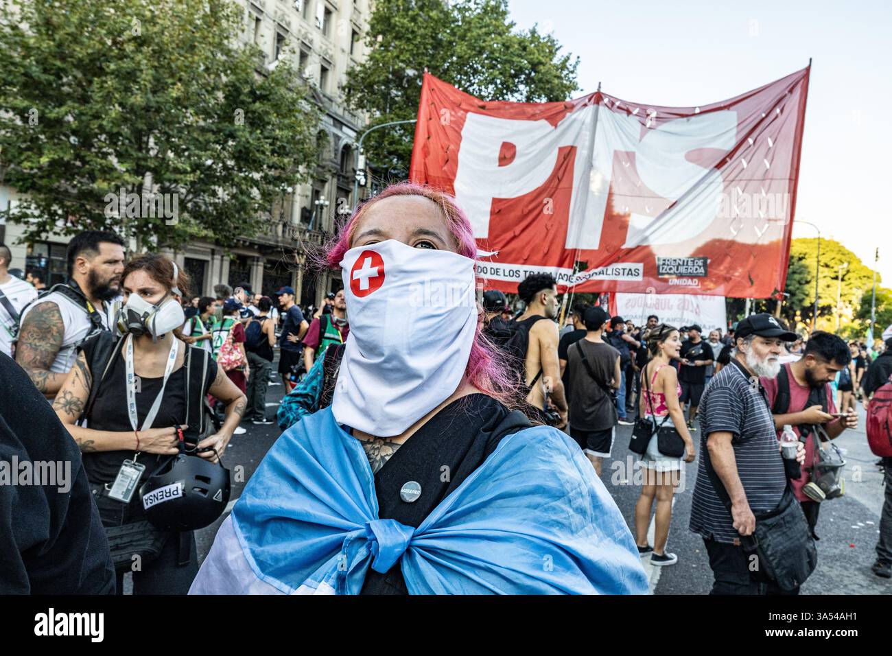 A young woman from the Red Cross participates in the protest. The ...
