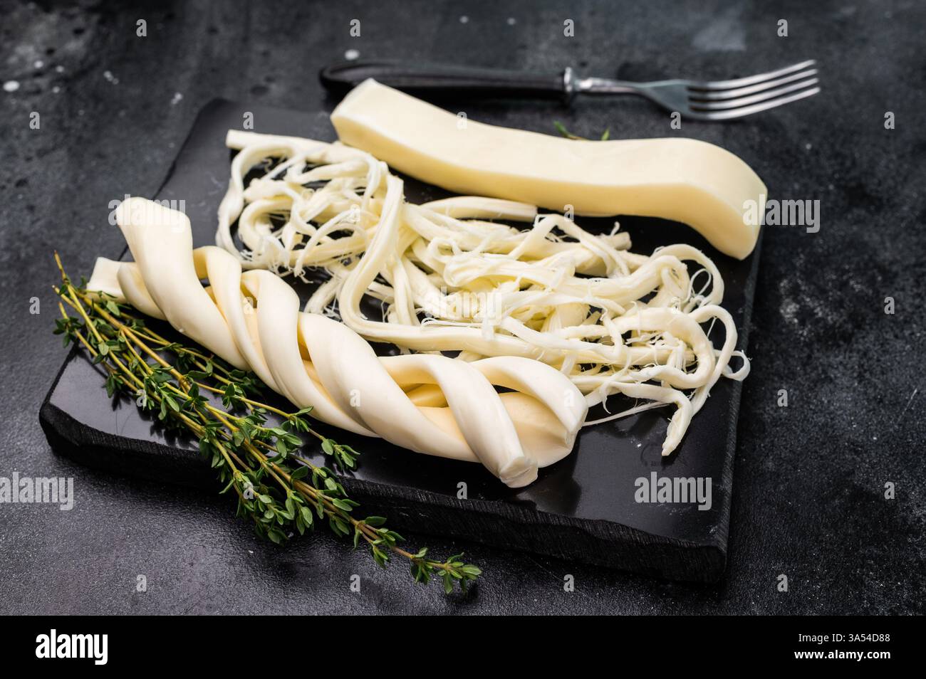 Assortiment of Traditional Caucasian Chechil white cheese on black ...