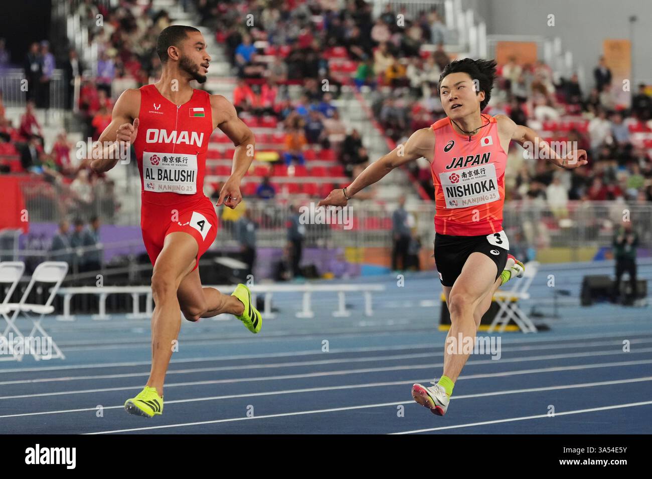 Ali Al Balushi of Oman, left, and Naoki Nishioka of Japan compete in ...