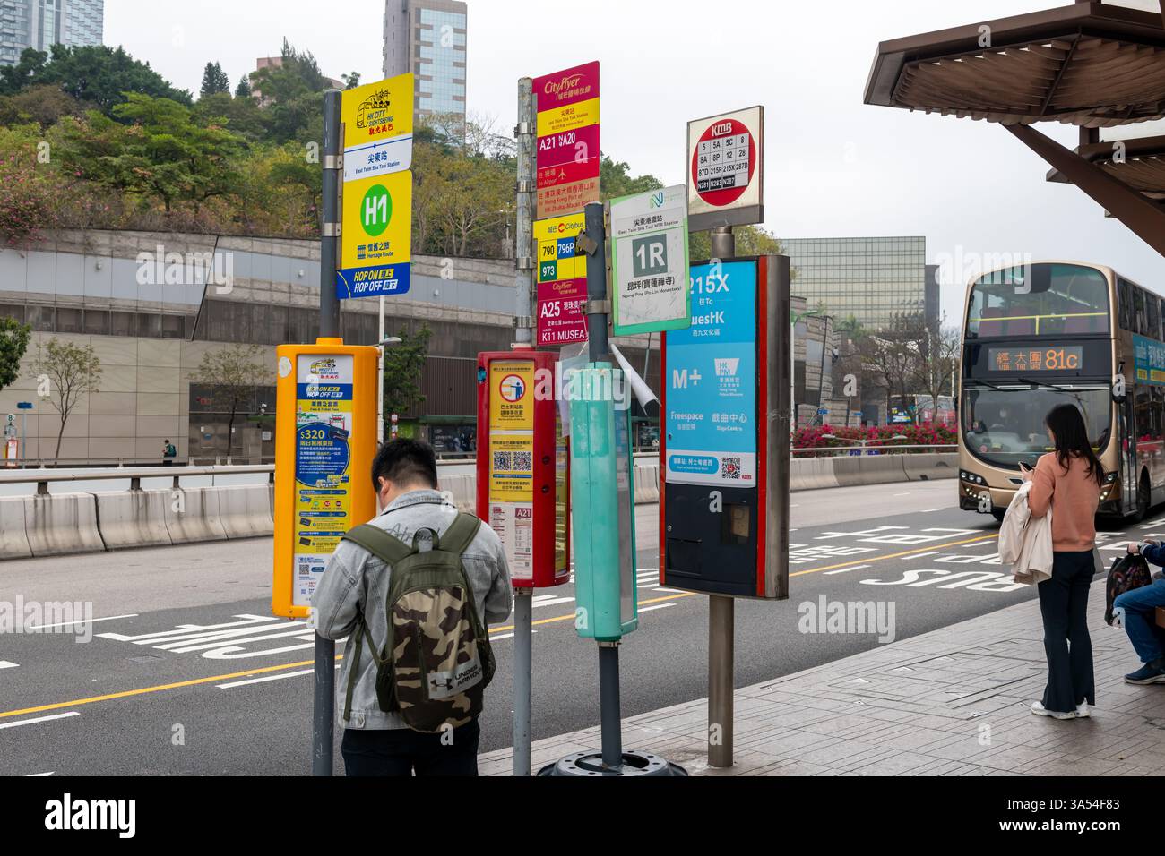 Hong Kong. China- 02.20.2025. A bus stop in East Tsim Sha Tsui with ...