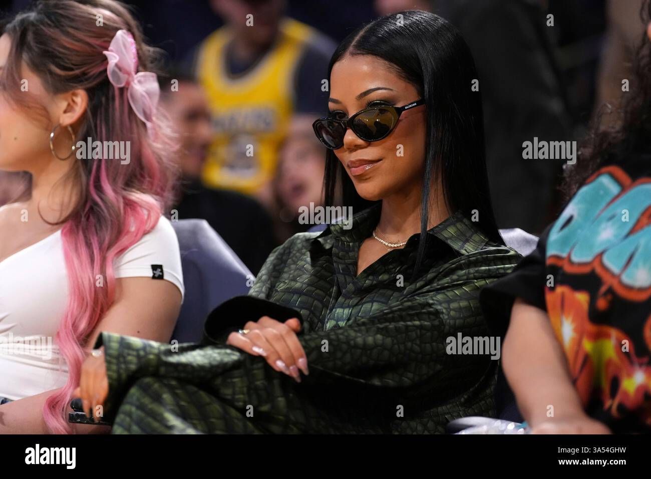 Entertainer Jhené Aiko watches during the second half of an NBA ...
