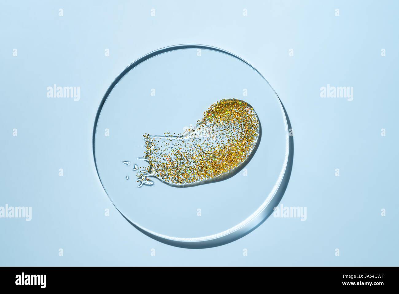 Liquid gel gold. transparent gel liquid with golden glitter In a Petri ...