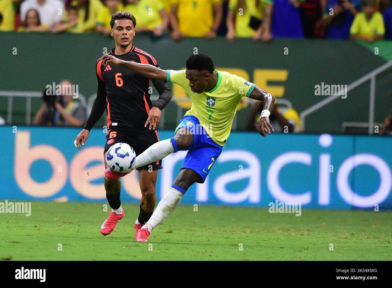 Brasilia, Brazil. 20th Mar, 2025. Vinicius Junior (R) of Brazil kicks ...