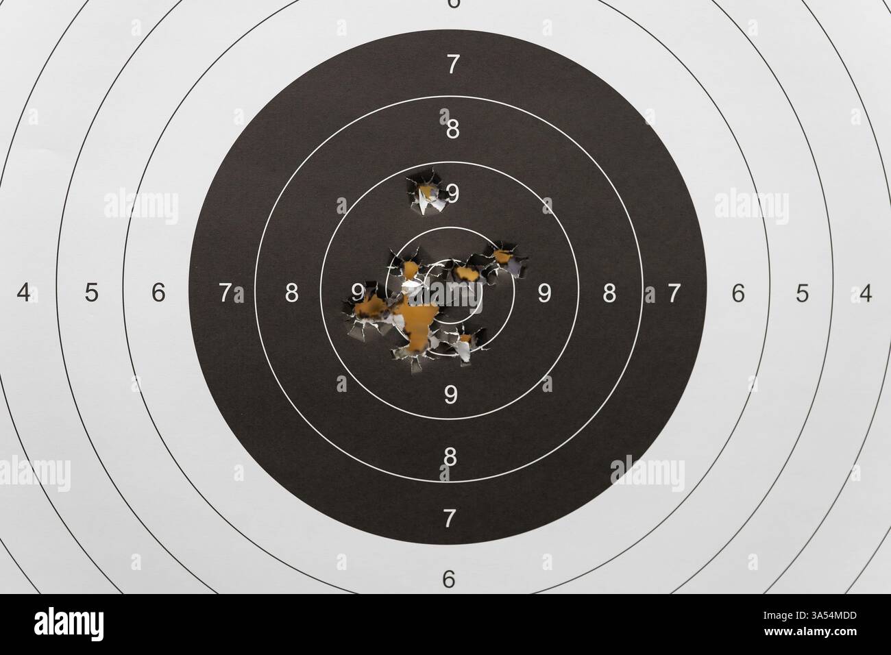 Bullseye shredded to pieces: close-up of bullet impacts demonstrating ...
