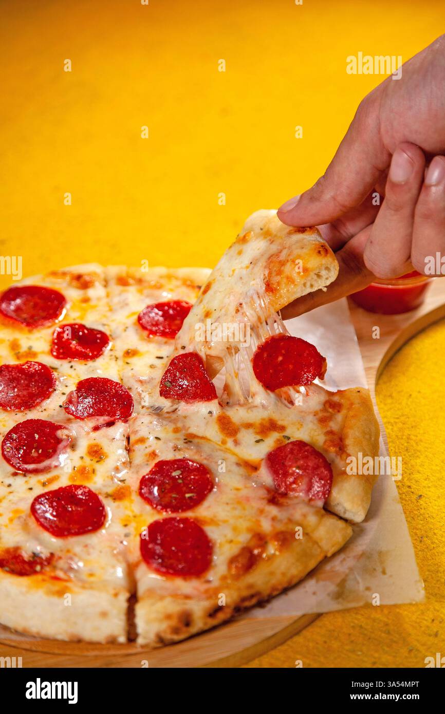Napolean style wood fired flat bread pepperoni pizza on a white and ...