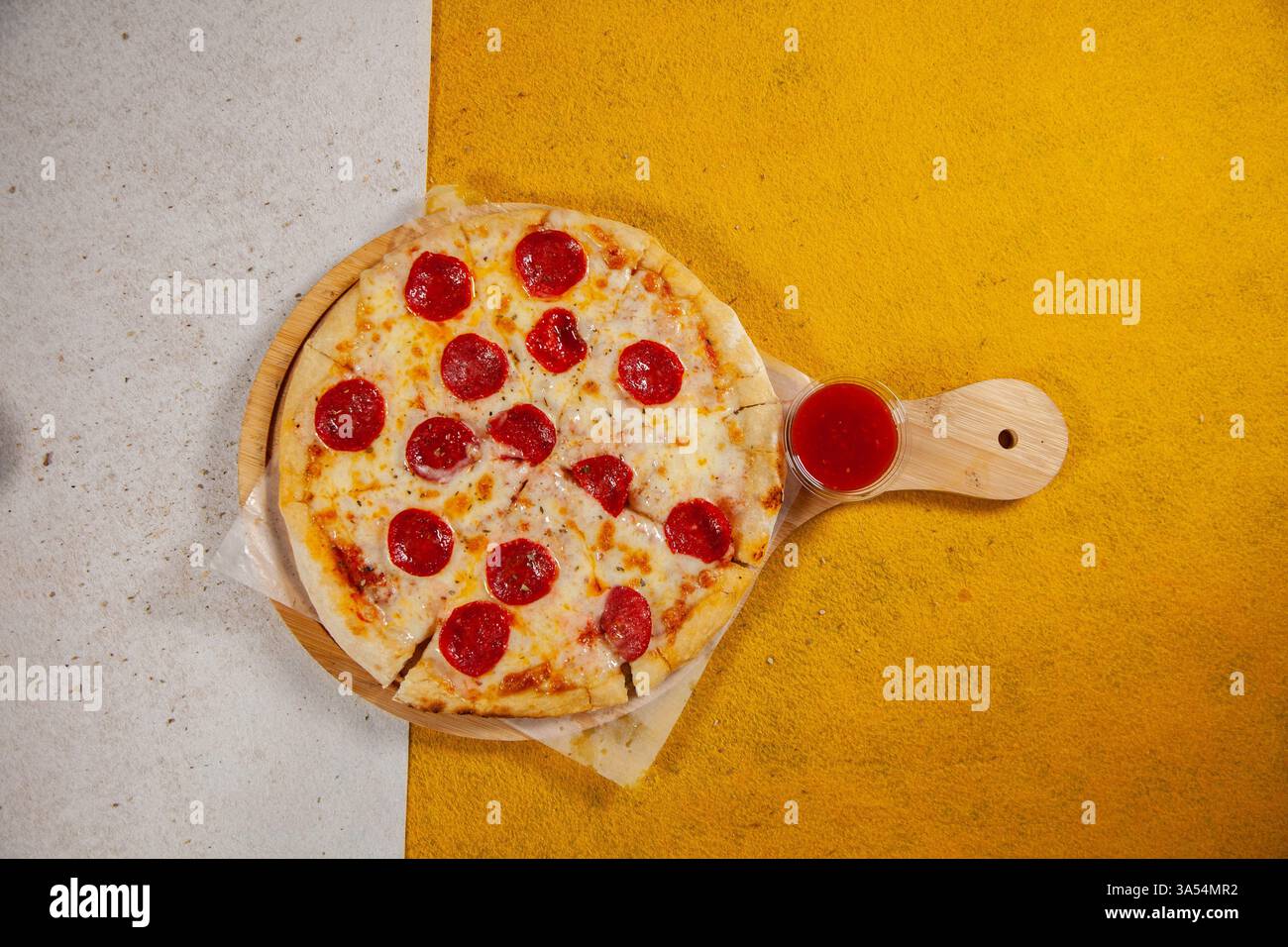 Napolean style wood fired flat bread pepperoni pizza on a white and ...