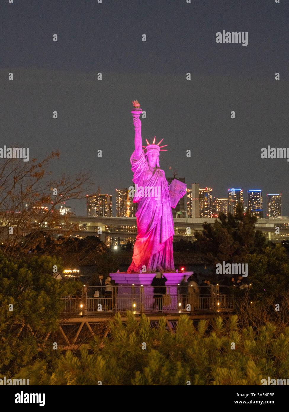 Odaiba, Tokyo, Japan. A miniature Statue Of Liberty lighten up in pink ...