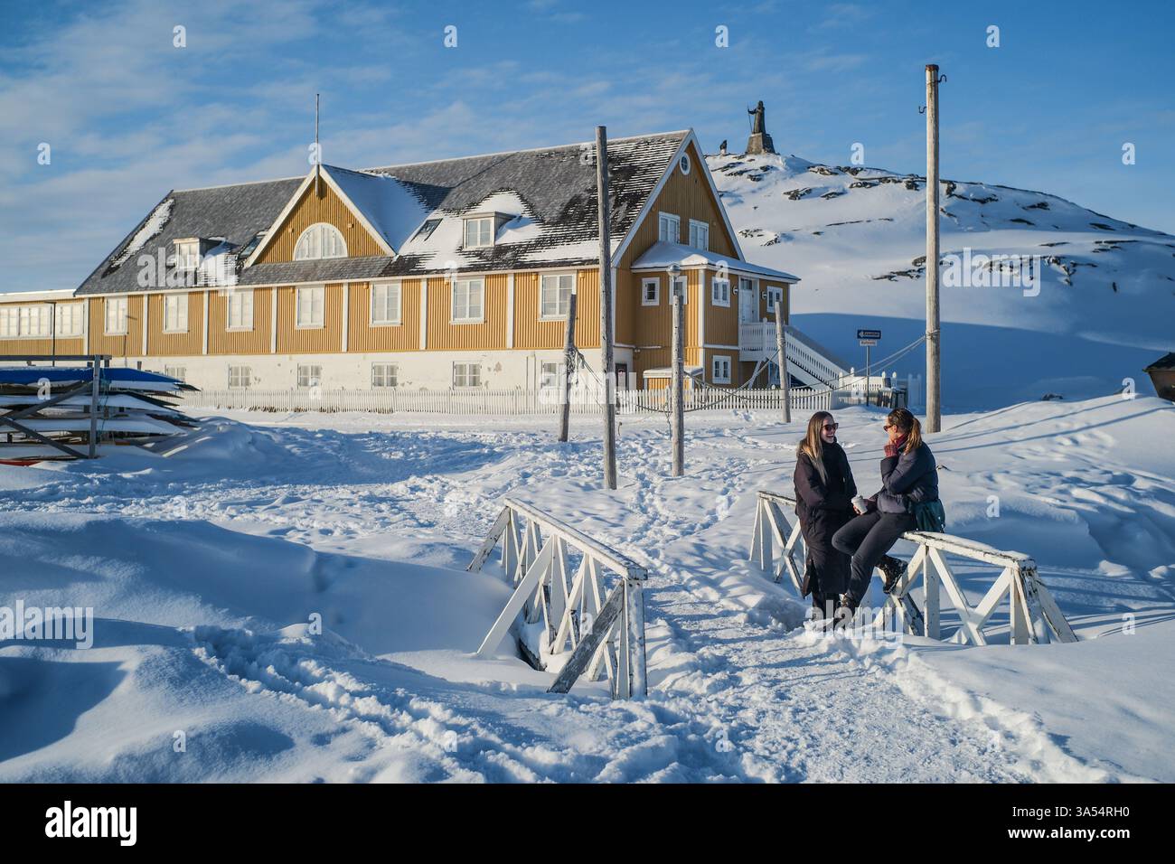 Nuuk, Denmark. 20th Mar, 2025. Two women chat on a bridge in Nuuk ...