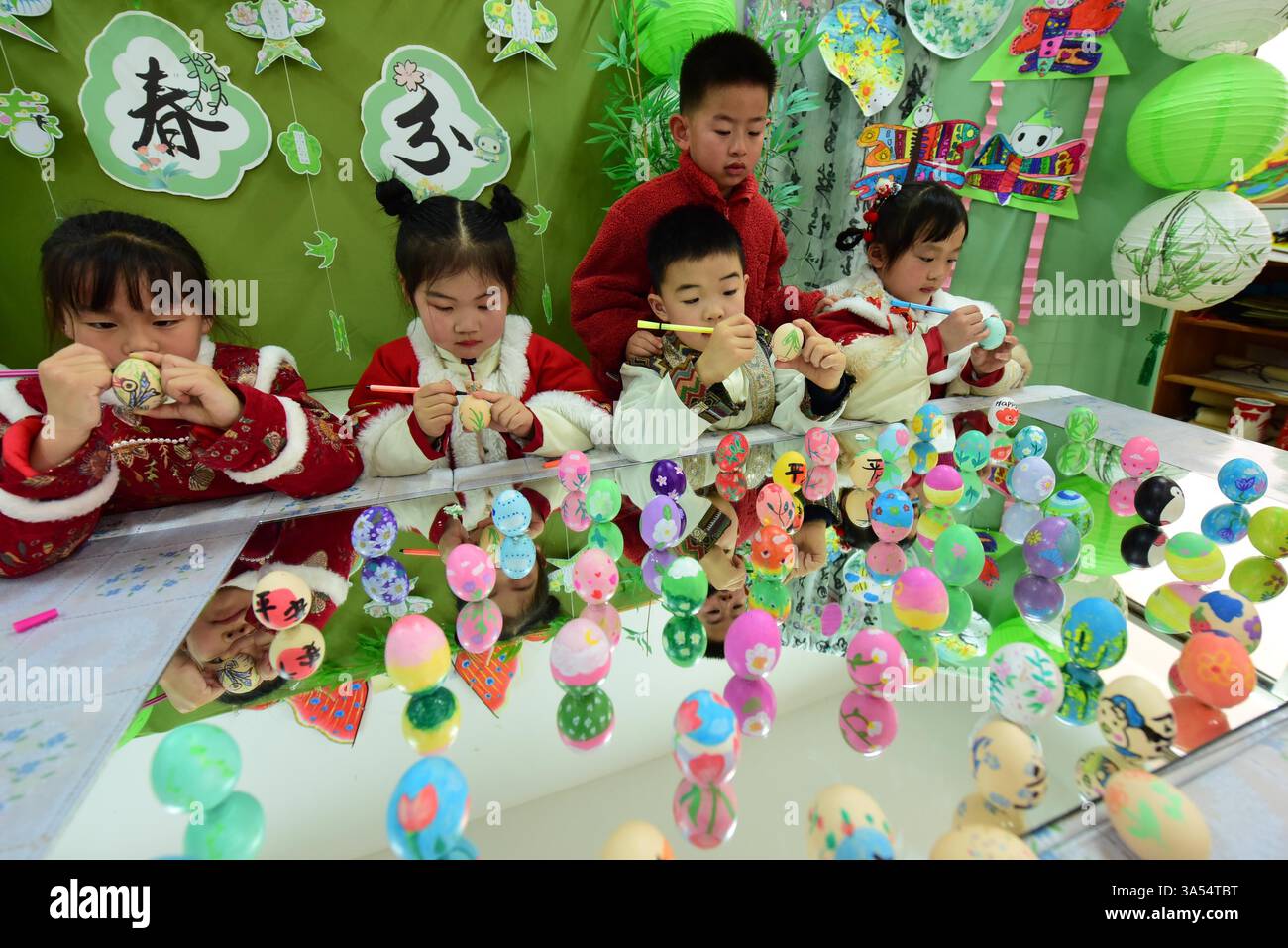 Children at a kindergarten paint eggs to welcome the spring equinox in ...