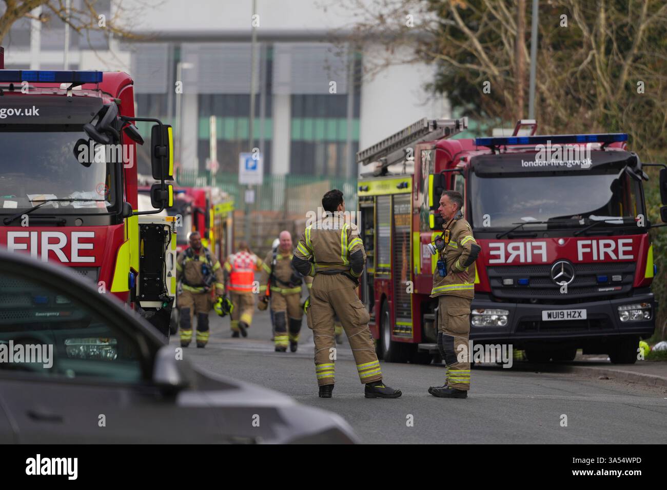 Firefighters wait at the area around the North Hyde electrical ...