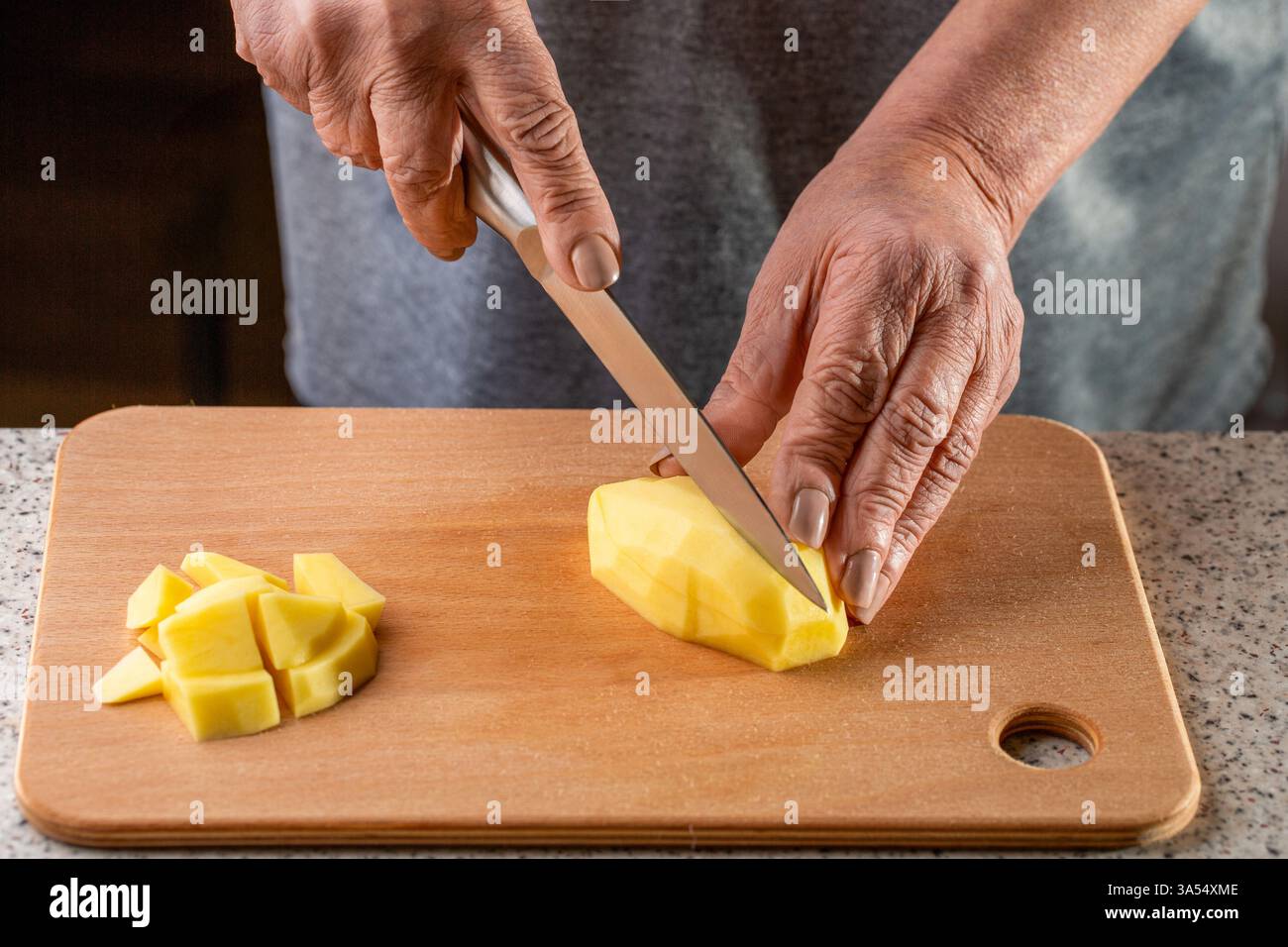 Process cutting potatoes woman cuts hi-res stock photography and images ...