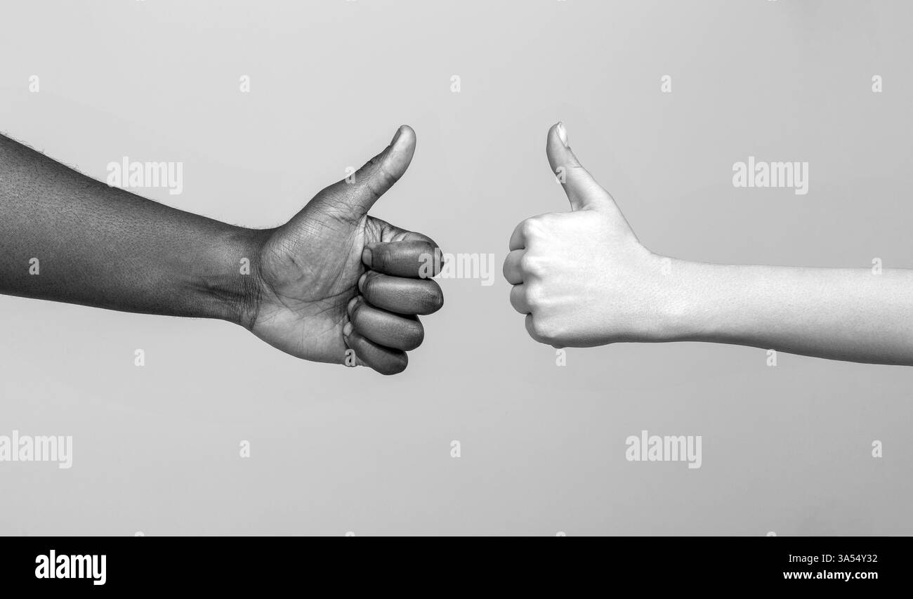 Thumb up. Black and white hands showing like together. Woman hands ...