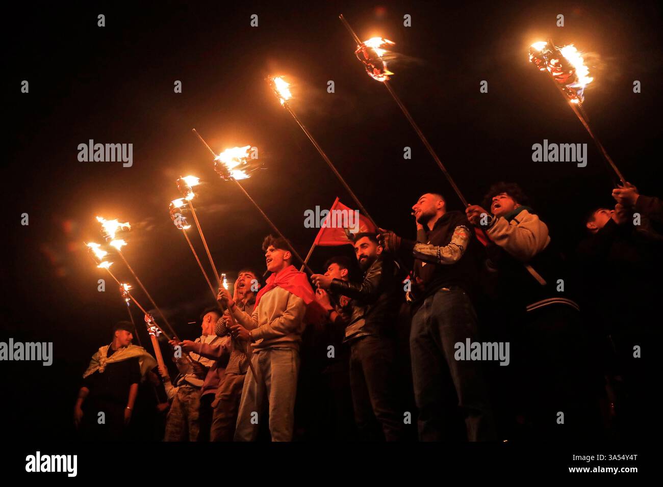 Syrian Kurds holding lit torches celebrate their Nowruz, the Kurdish ...