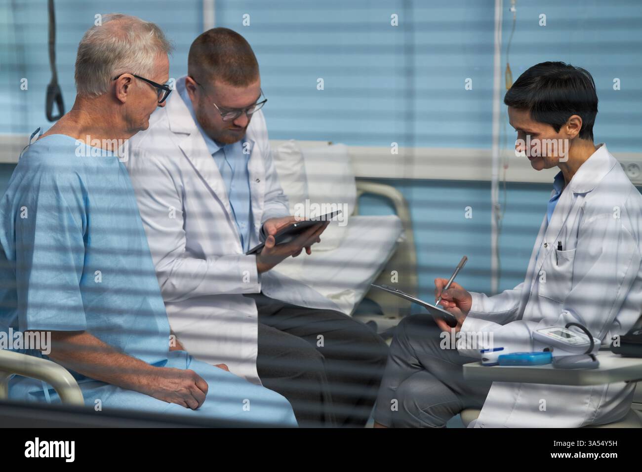 Discussing Patient's Health Conditions in Hospital Room Stock Photo - Alamy