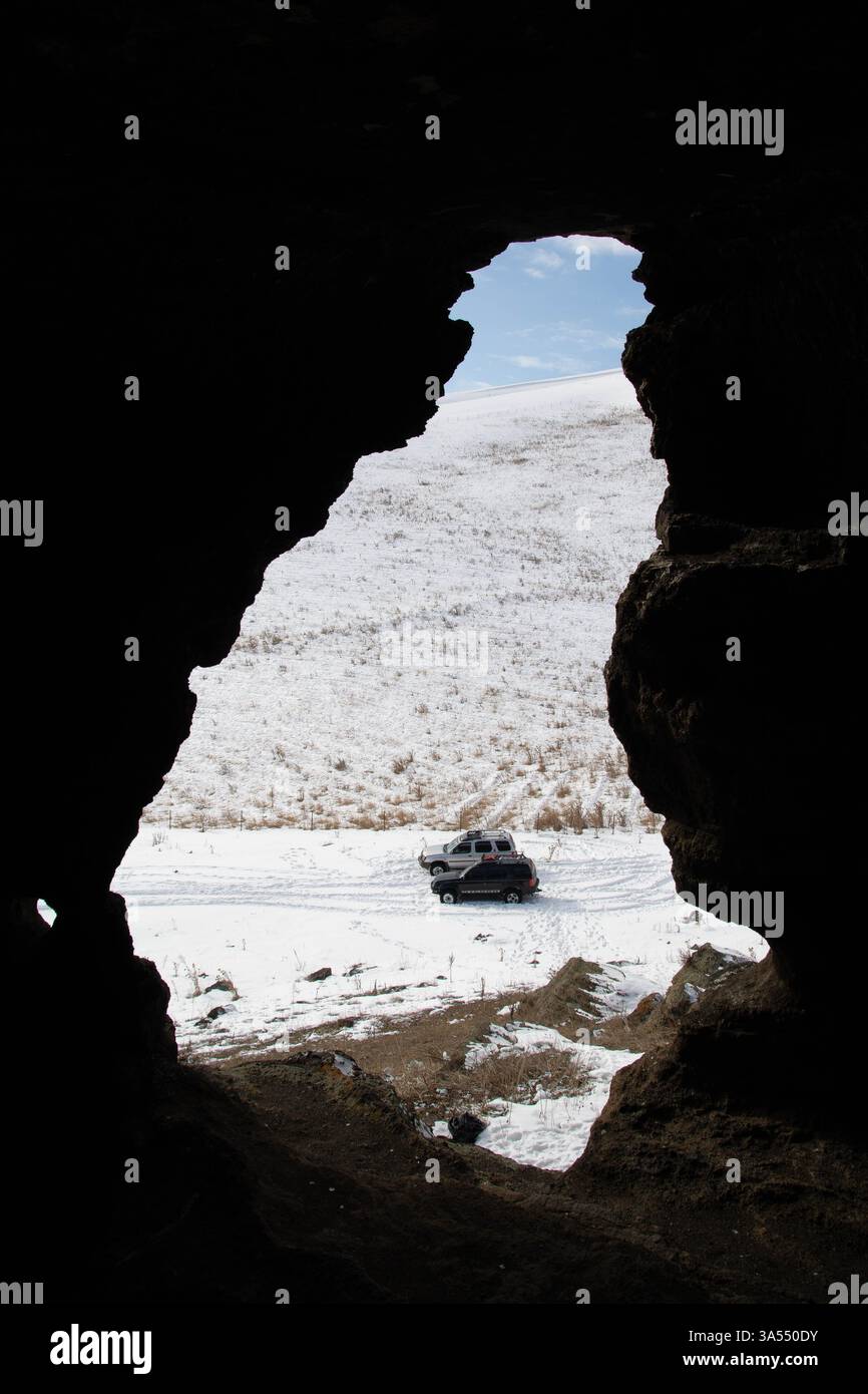 Cave on the rock. Entrance and windows of the cave. Beautiful view from ...
