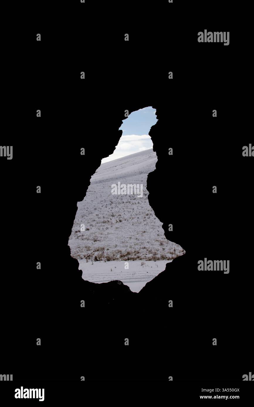 Cave on the rock. Entrance and windows of the cave. Beautiful view from ...