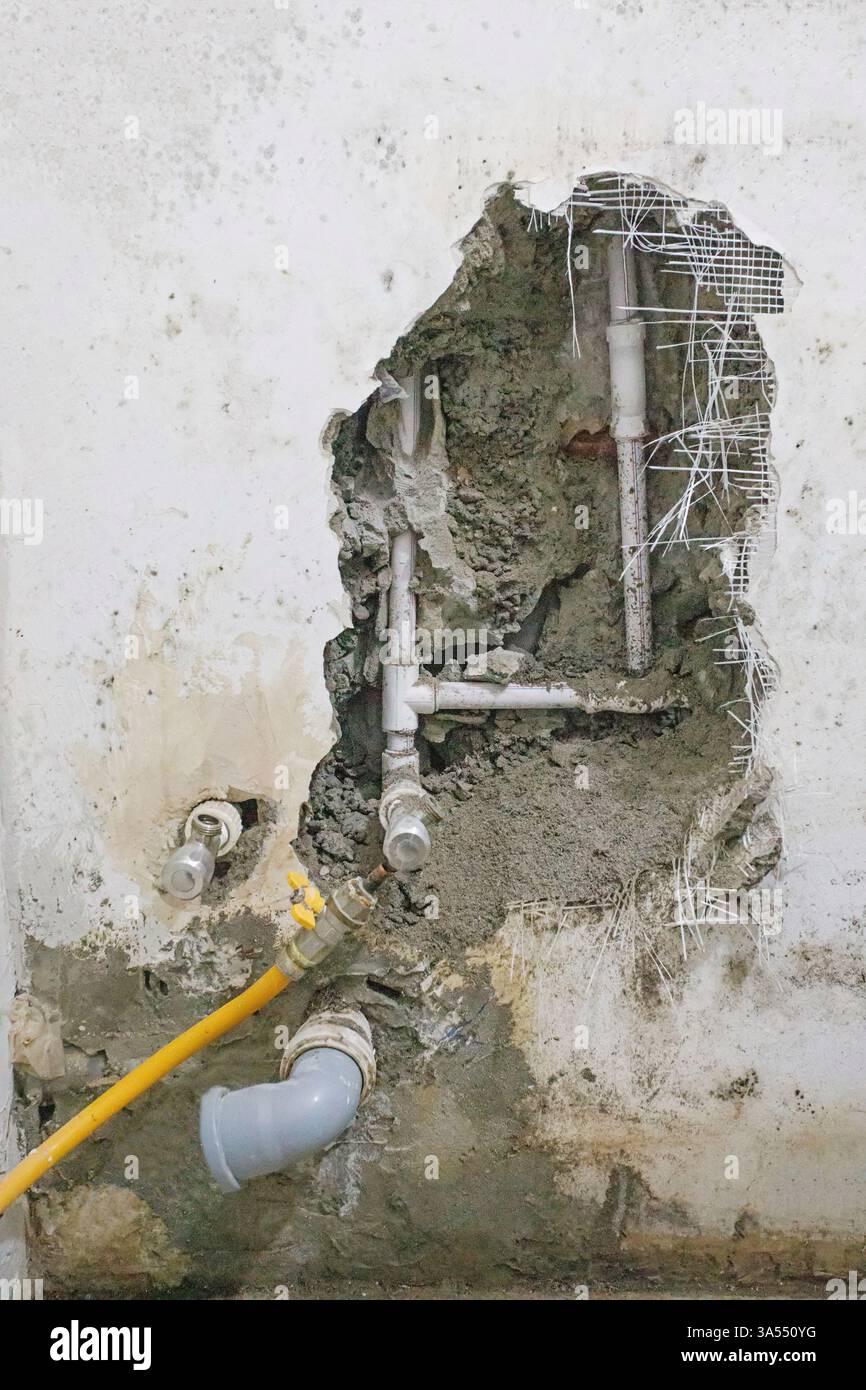 Hole in old building, drain pipes, renovating plumbing Stock Photo - Alamy