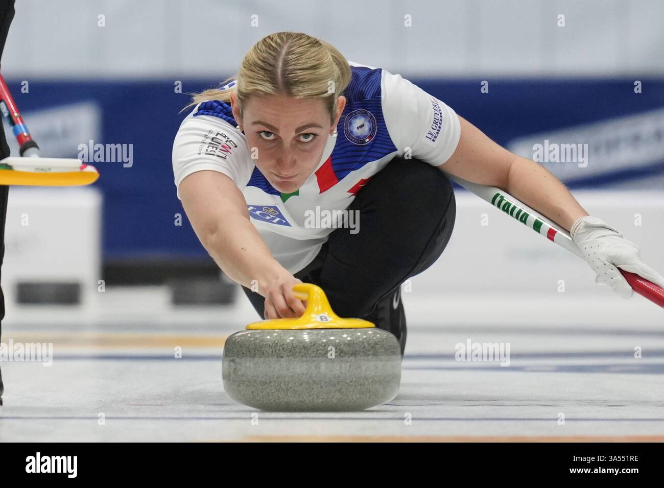 Italy's Elena Mathis releases the stone during the match against Canada ...
