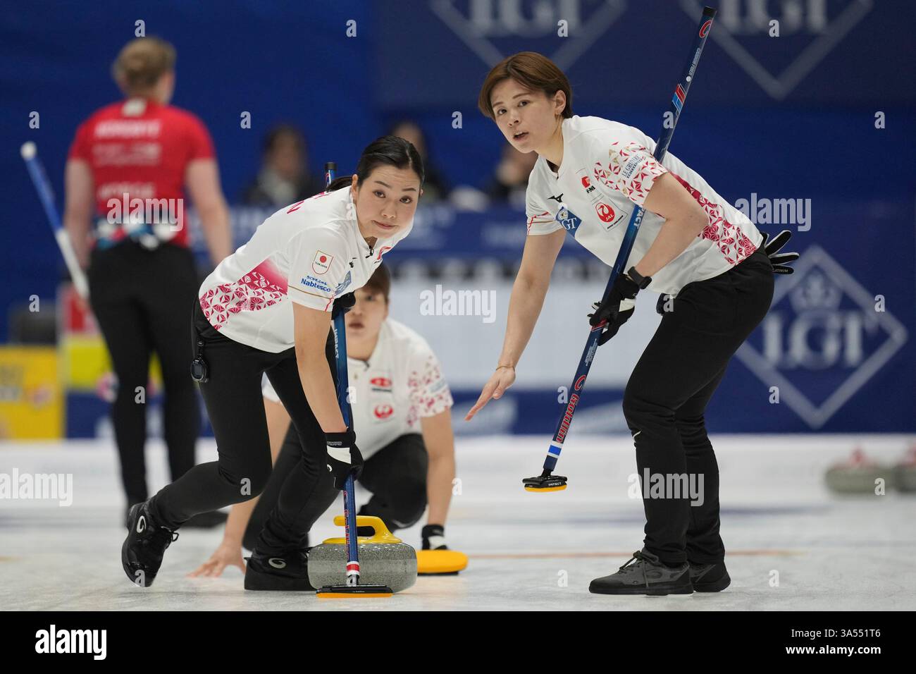 Japan's Anna Ohmiya, left, and Kaho Onodera, right, sweep during the ...