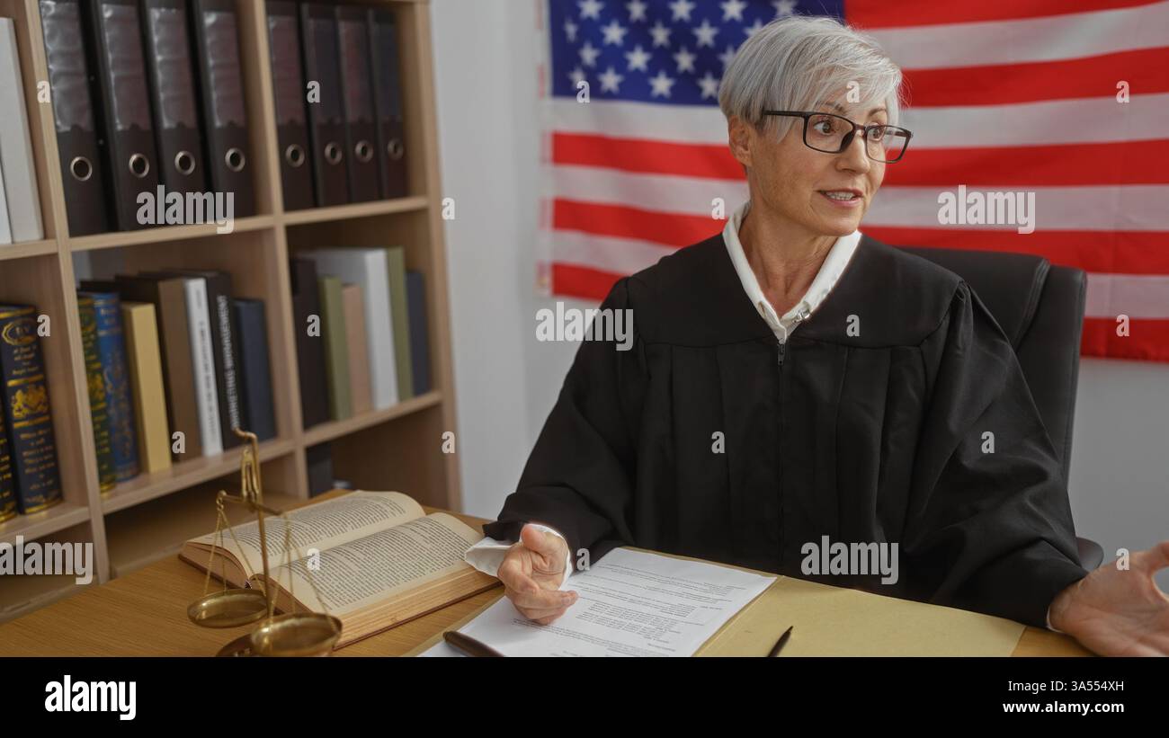Elderly female judge with short grey hair sitting in a courtroom with ...