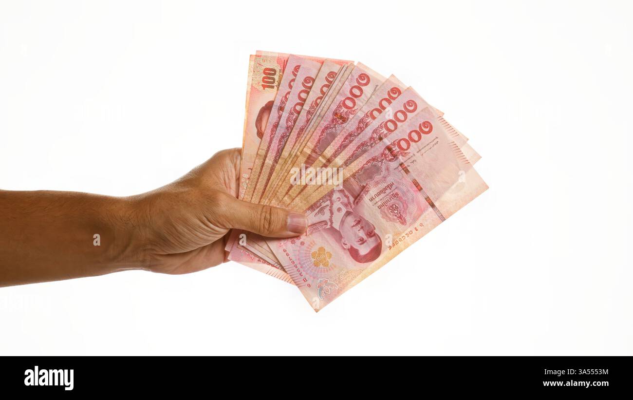 Hand holding thai baht money isolated over white background showing ...