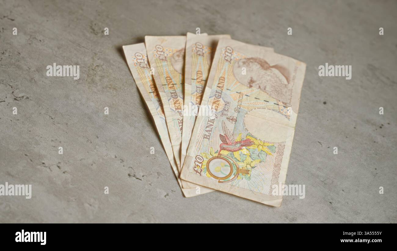 British banknotes in denominations of ten pounds are spread on a ...