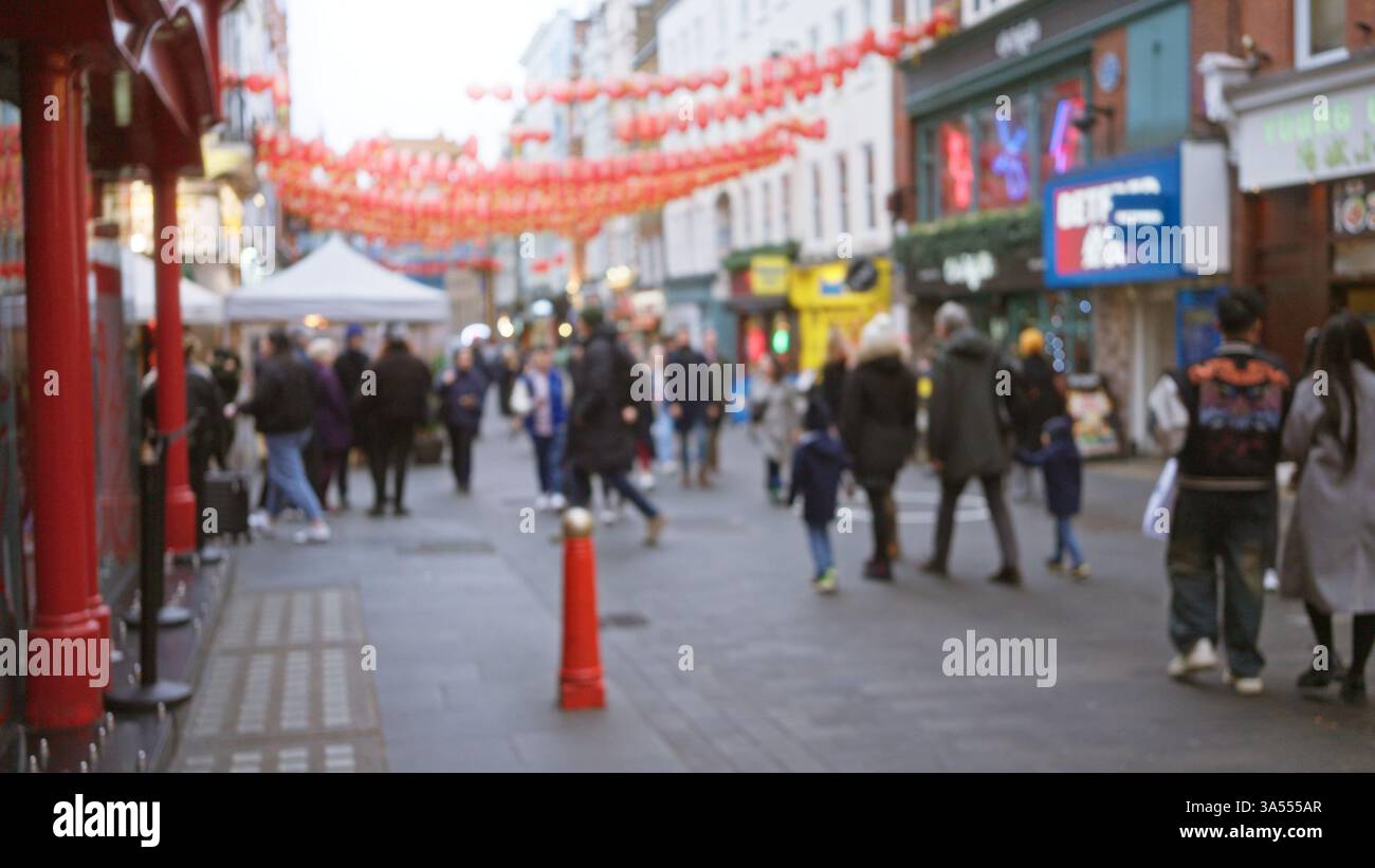 Busy street scene in london's chinatown capturing blurred winter crowds ...