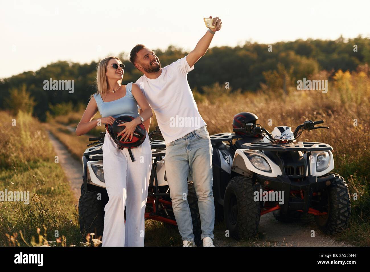 Making a selfie. Man and woman are on ATV outdoors Stock Photo - Alamy