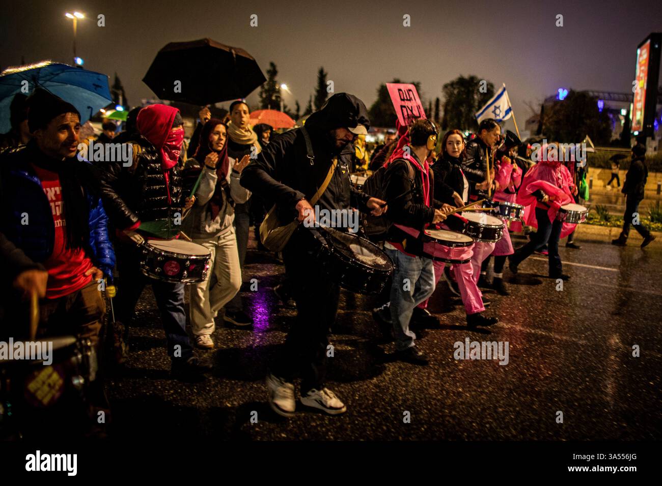 Protestors wave a sign that reads in Hebrew Ò The People will WinÓ as ...