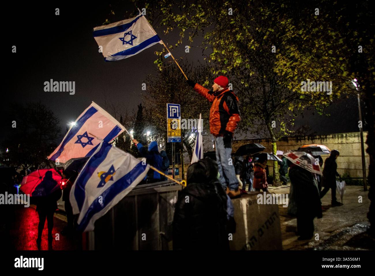 Israeli protestors wave their flag during a demonstration in Jerusalem ...