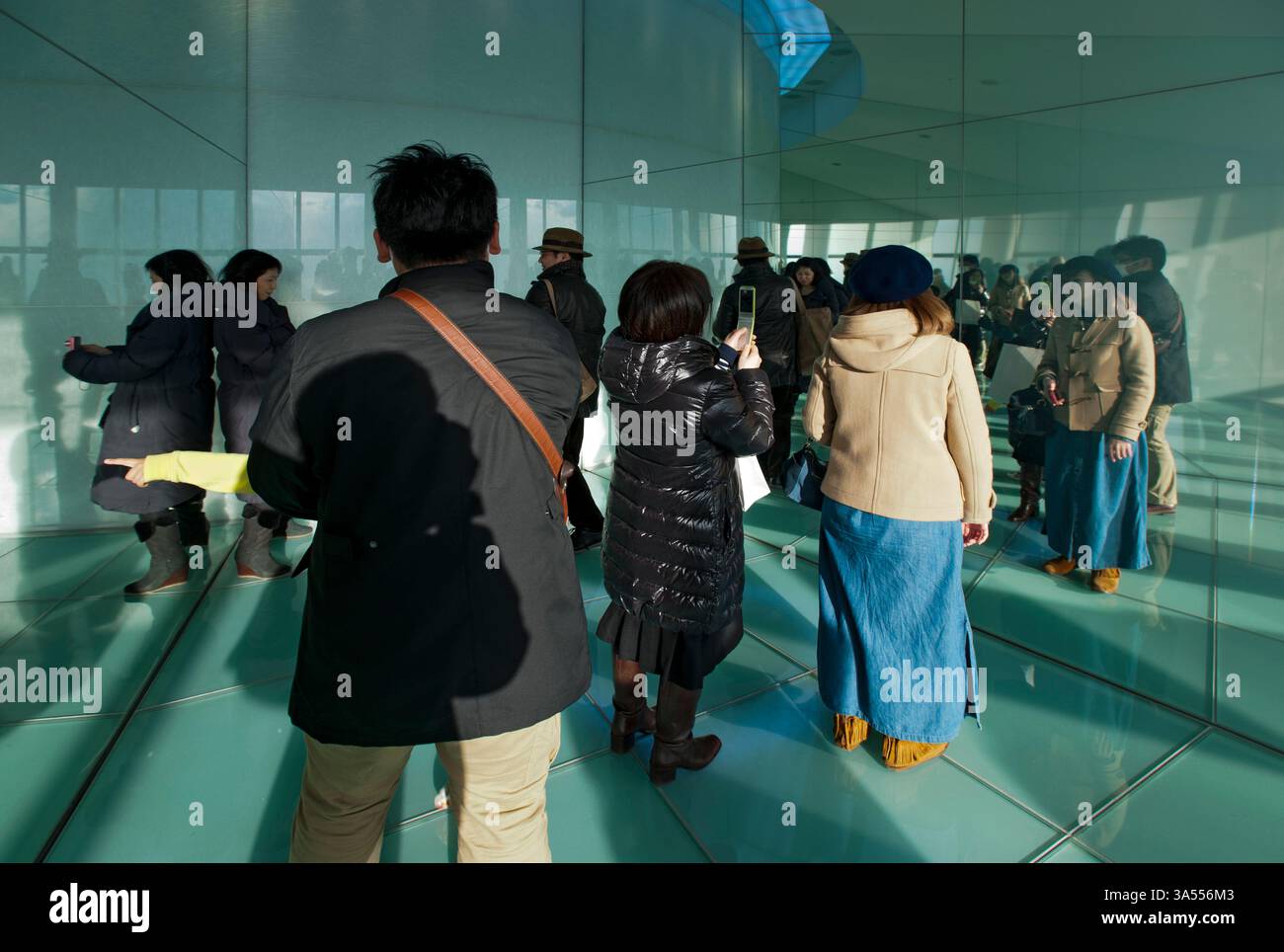 Visitors to the Tokyo Skytree enjoying the optical illusions inside the ...