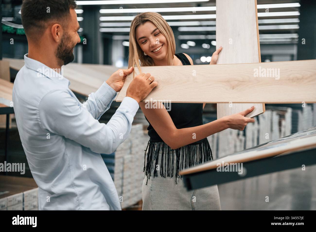 Making fun, color of parquet is the same as girlfriend hair. Man with ...