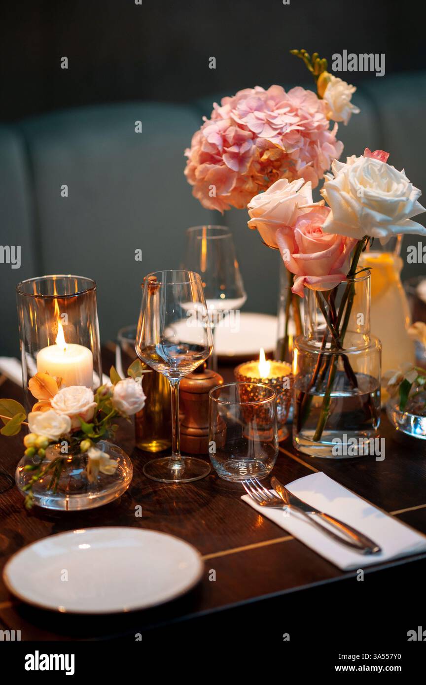 Elegant Dining Table with Floral Centerpieces Stock Photo - Alamy