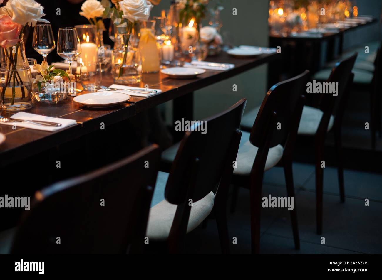 Elegant Dining Table Setup with Candles and Flowers Stock Photo - Alamy