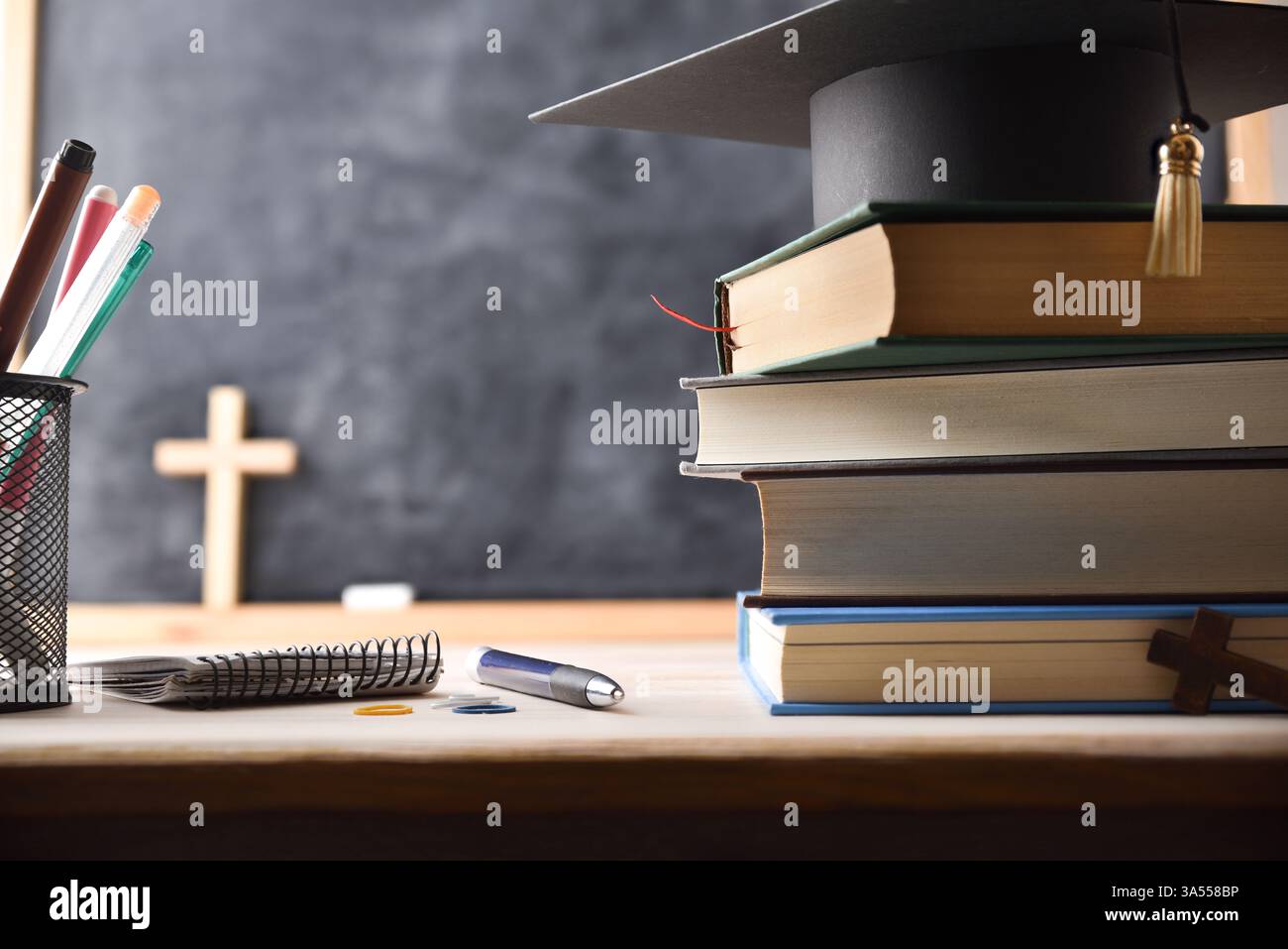 Stack of books mortarboard tools chalkboard hi-res stock photography ...