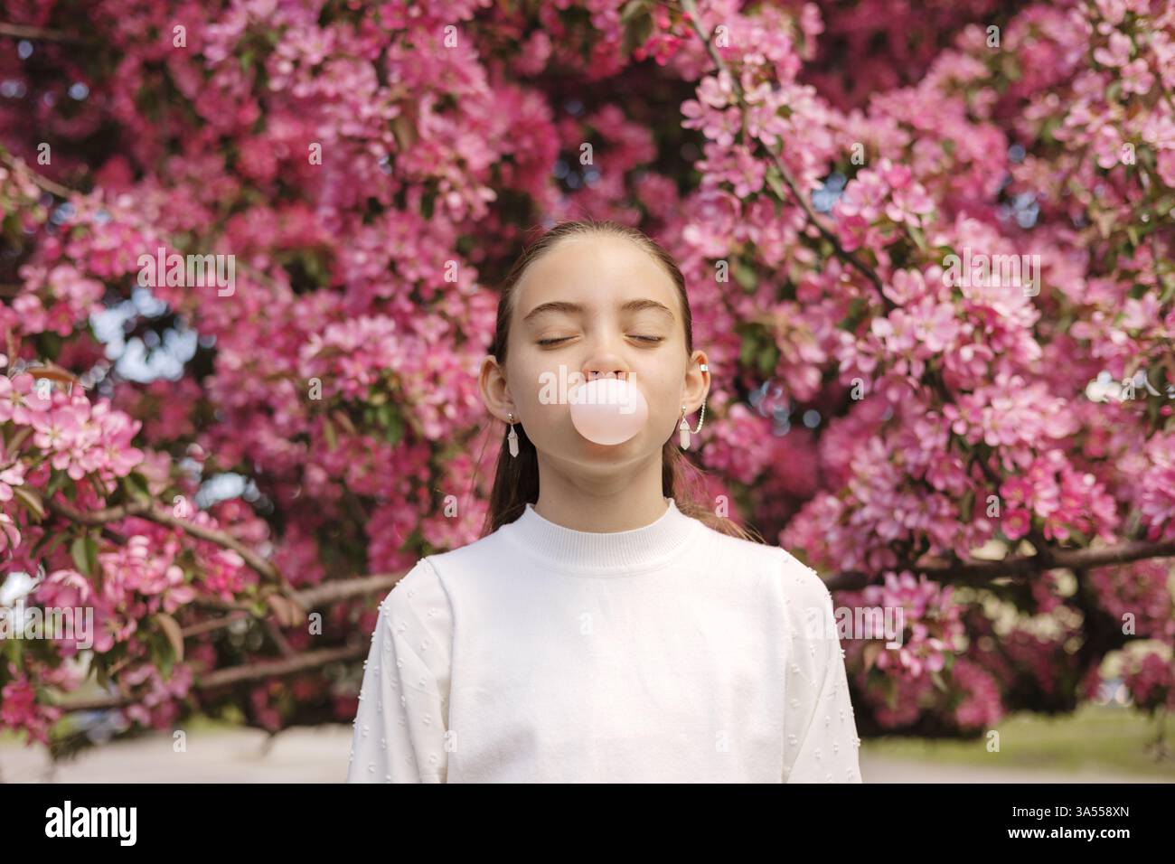 Preteen girl blowing bubble hi-res stock photography and images - Alamy