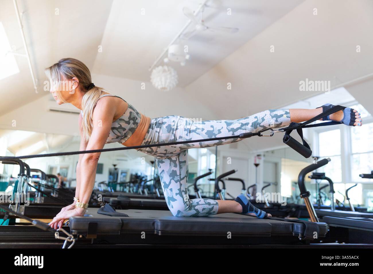 Woman Doing Leg Exercise on Lagree Reformer Stock Photo - Alamy