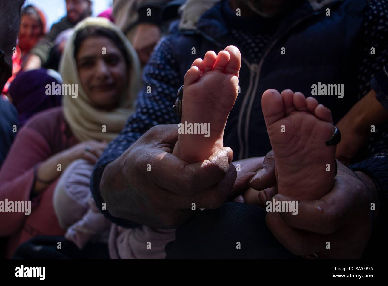 March 21, 2025, Srinagar, Jammu And Kashmir, India: A girl receives ...