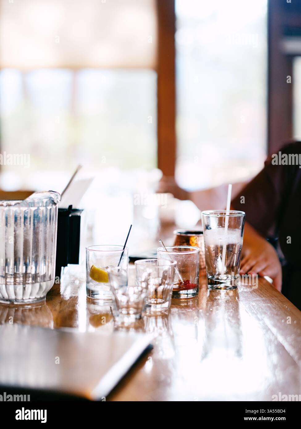 A wooden bar counter with empty cocktail glasses Stock Photo - Alamy