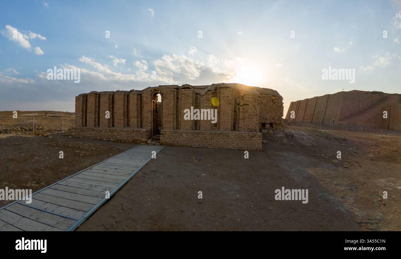 Ancient brick ruins city of Ur in Iraq under a bright sky with sun rays ...